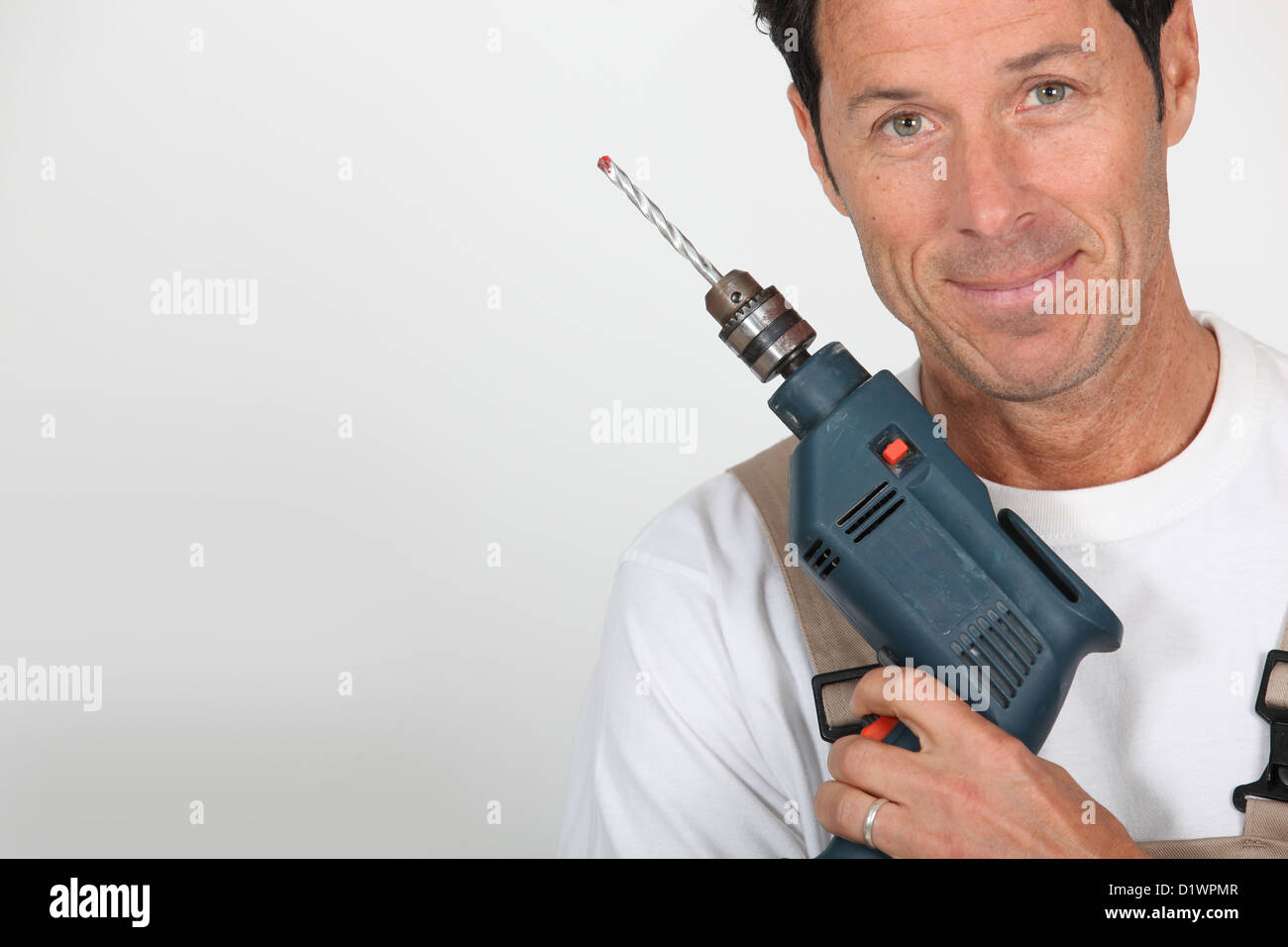 Man with drill Stock Photo - Alamy