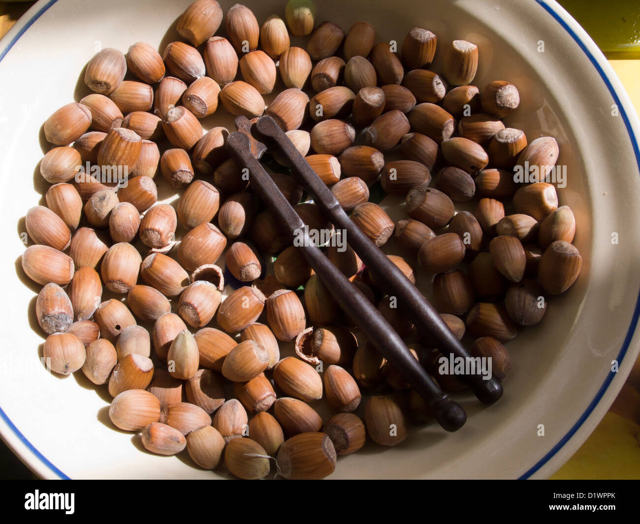 Antique nutcracker in bowl of hazelnuts Stock Photo - Alamy