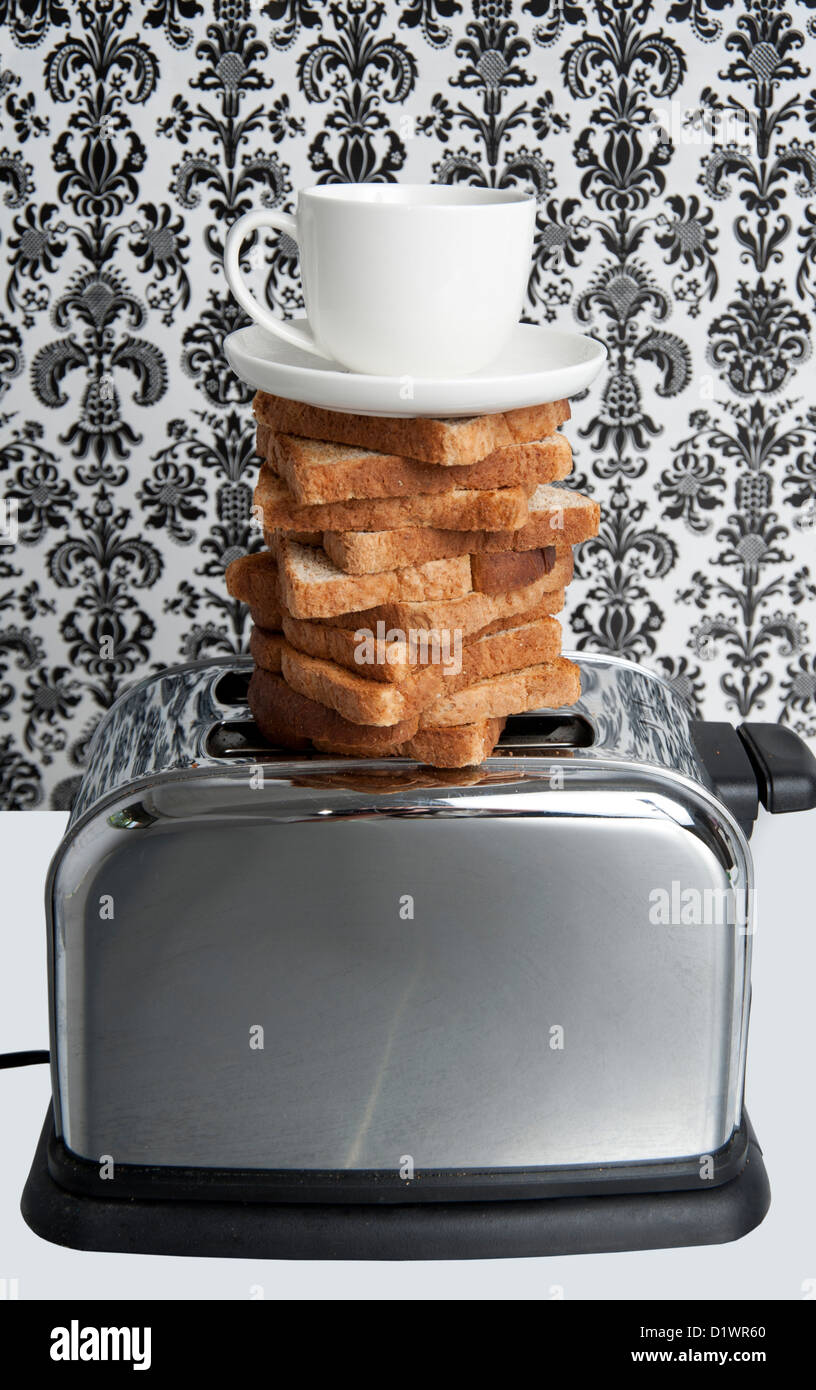 Toast and coffee balanced on top of a toaster Stock Photo - Alamy