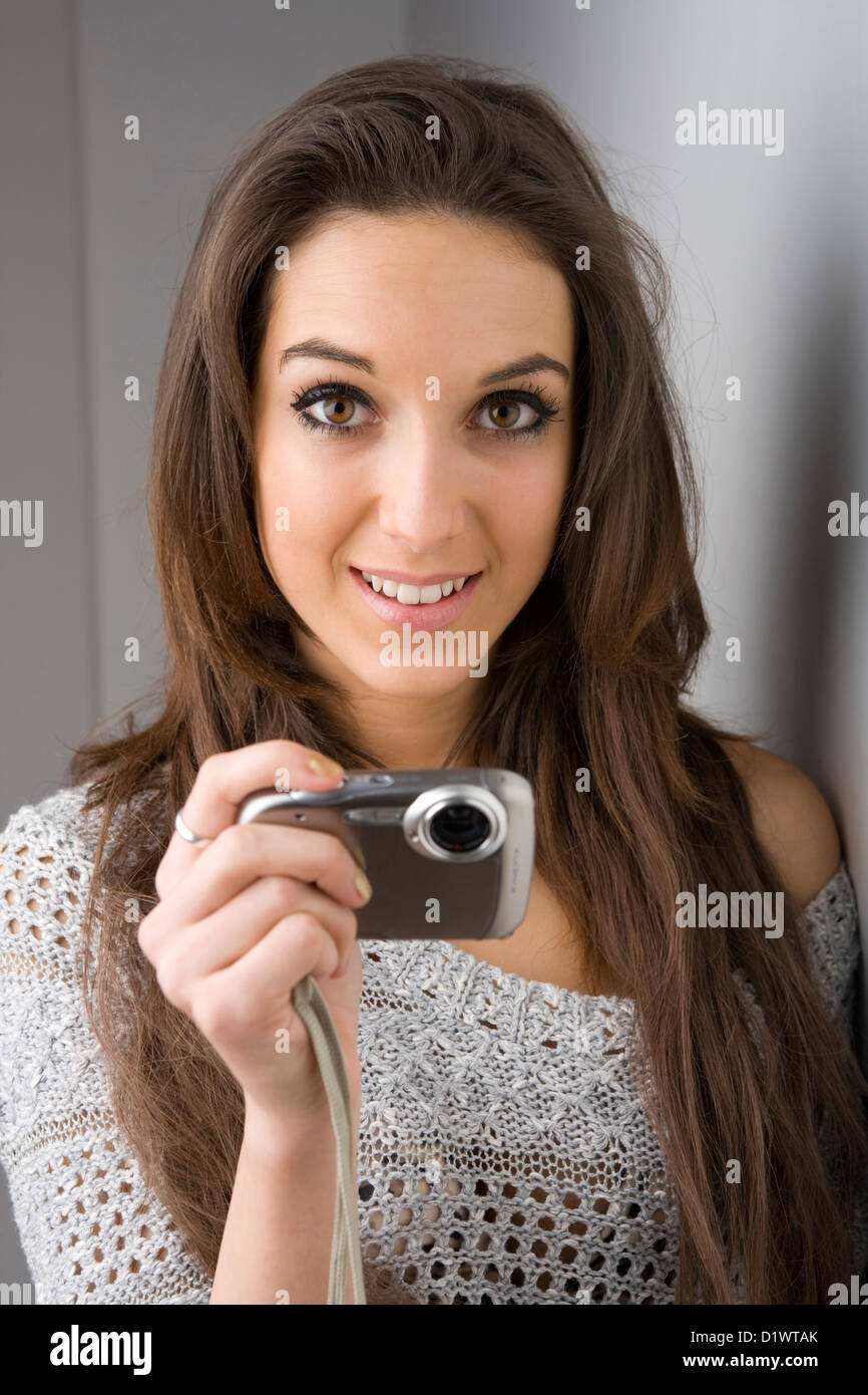 Young woman holding a compact camera in her hand Stock Photo - Alamy