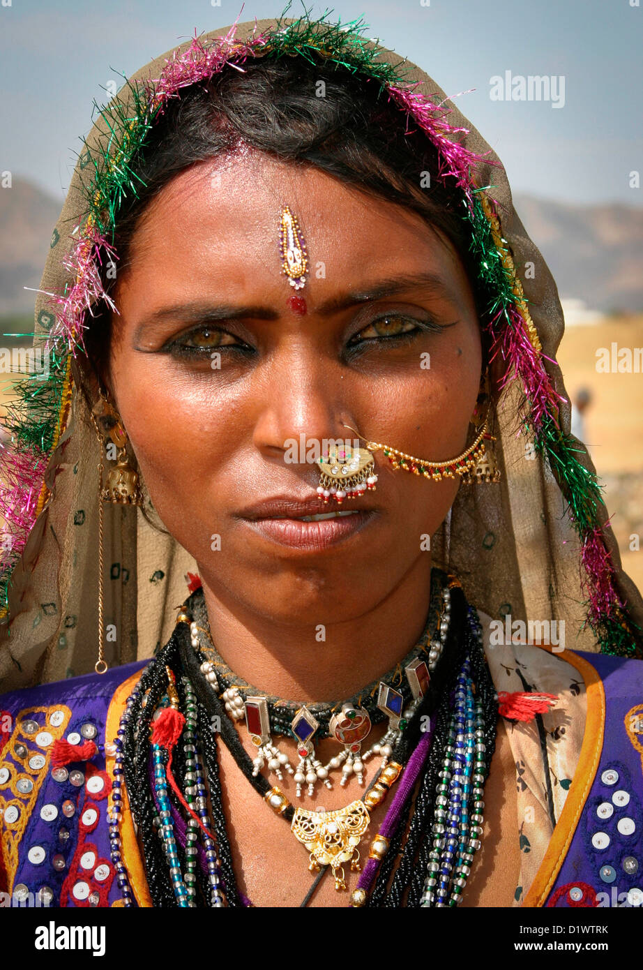 Portrait of a beautiful Rajasthani woman wearing traditional colourful ...