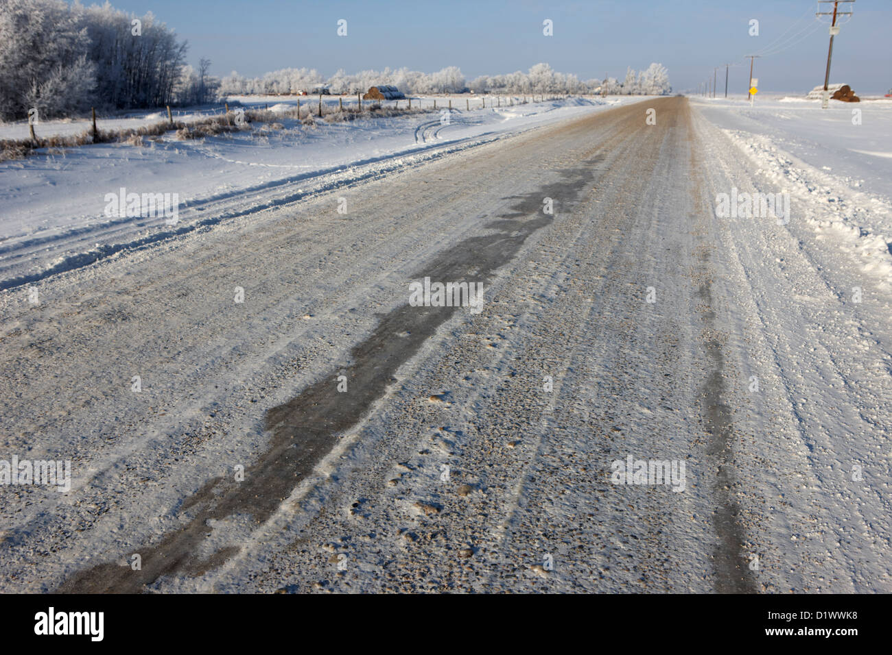 frozen salt and grit covered rural small road in Forget Saskatchewan ...