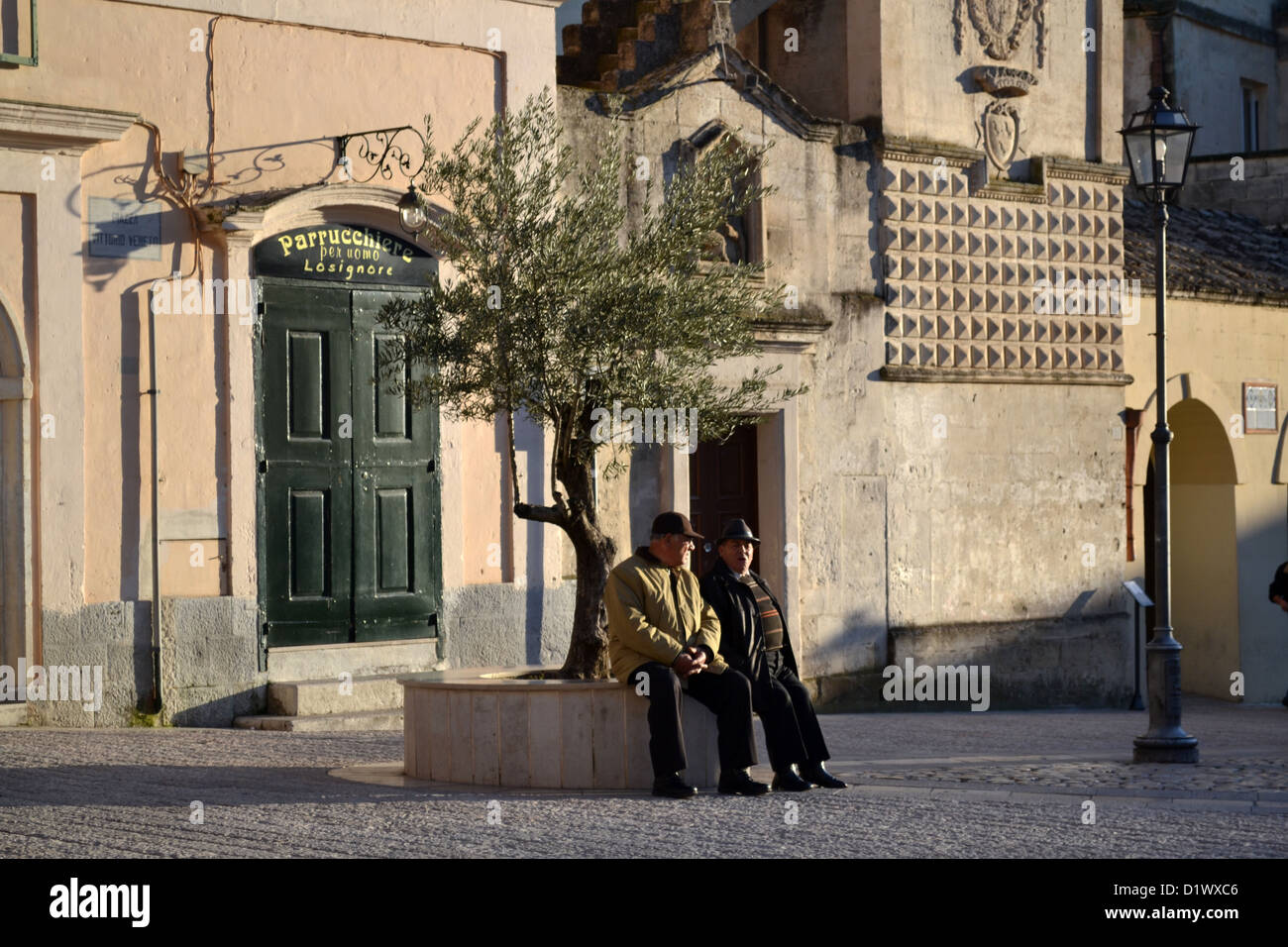 Old men talking in main square in Matera, town, Basilicata region ...