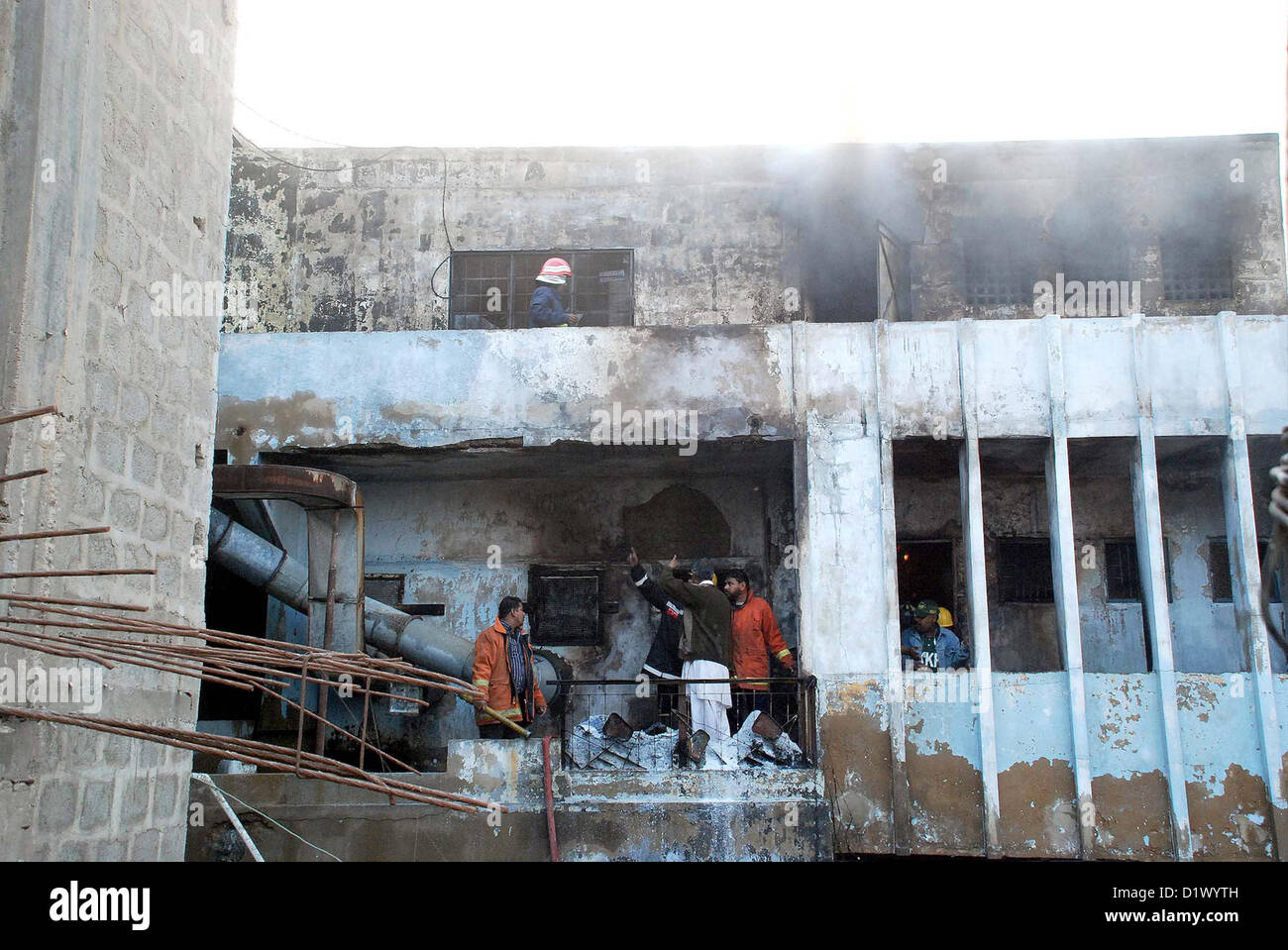 Fire fighters extinguishing fire in a chemical factory that caught fire ...
