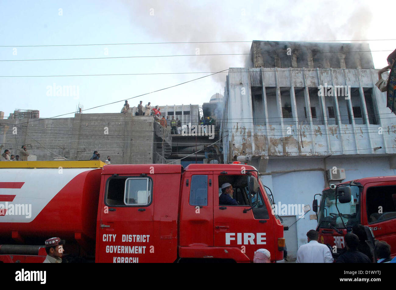 Fire fighters extinguishing fire in a chemical factory that caught fire ...