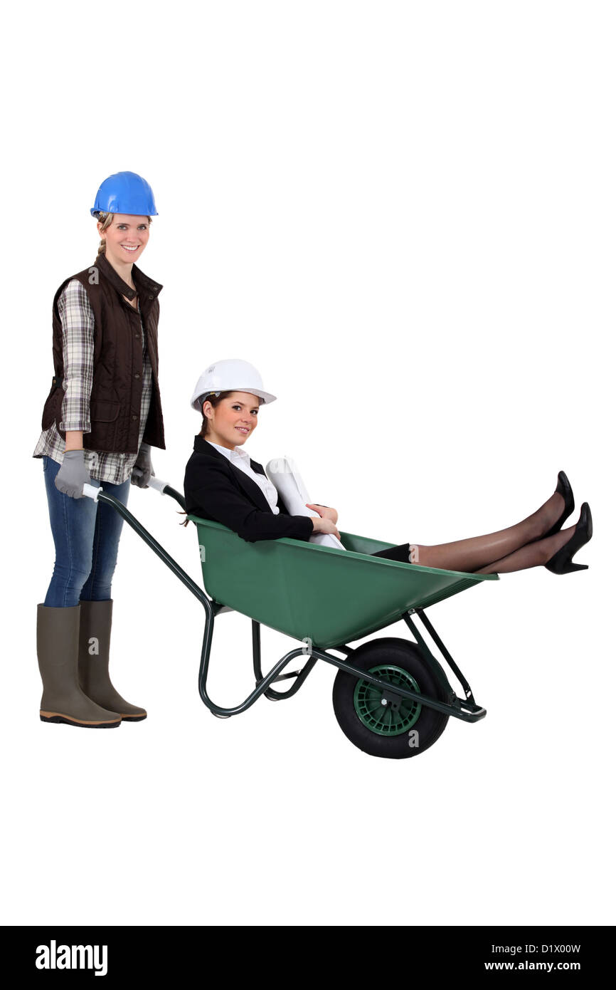 Construction Worker Pushing A Wheelbarrow High Resolution Stock ...