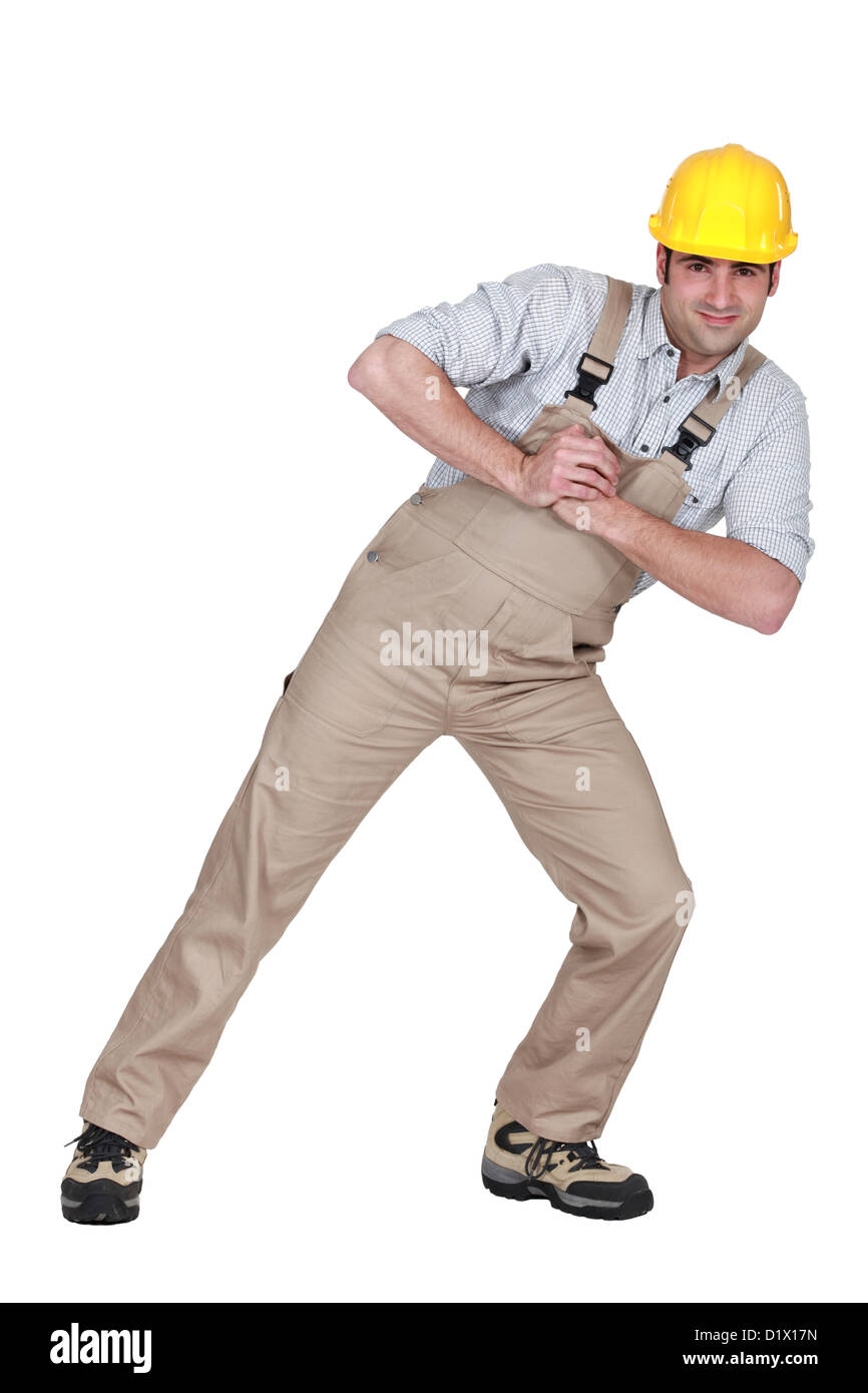 Builder leaning against wall Stock Photo - Alamy
