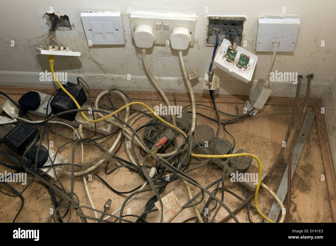 dusty power cables and electrical plugs in a British household Stock ...