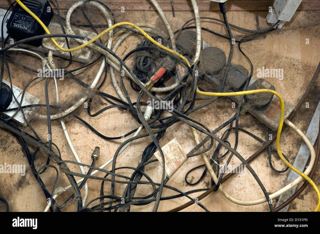 dusty power cables and electrical plugs in a British household Stock ...