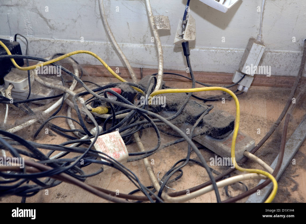 dusty power cables and electrical plugs in a British household Stock ...