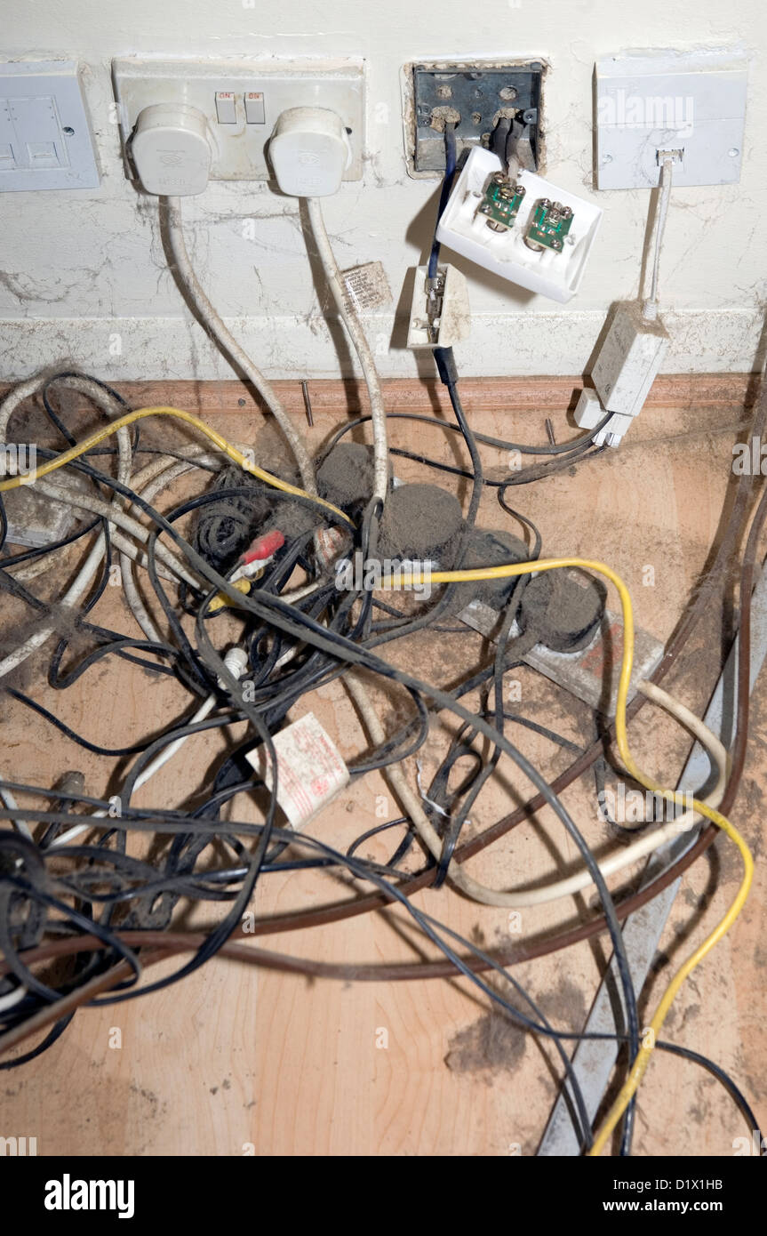 dusty power cables and electrical plugs in a British household Stock ...