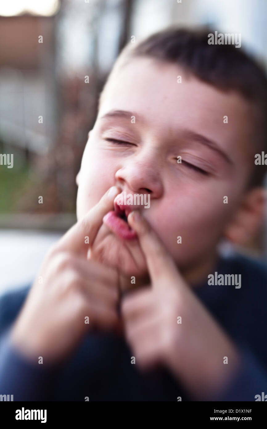 Little Boy making faces and being silly outside of his house Stock ...