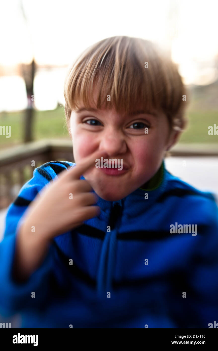 Little Boy making faces and being silly outside of his house Stock ...