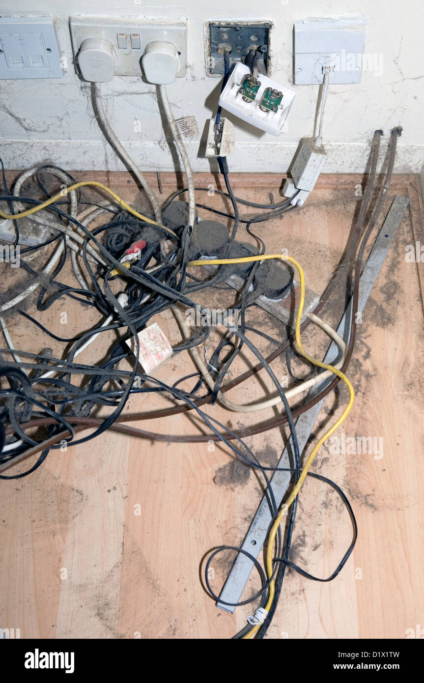 dusty power cables and electrical plugs in a British household Stock ...