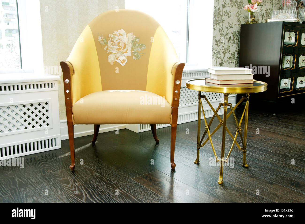 comfortable upholstered chairs and a coffee table with books Stock ...