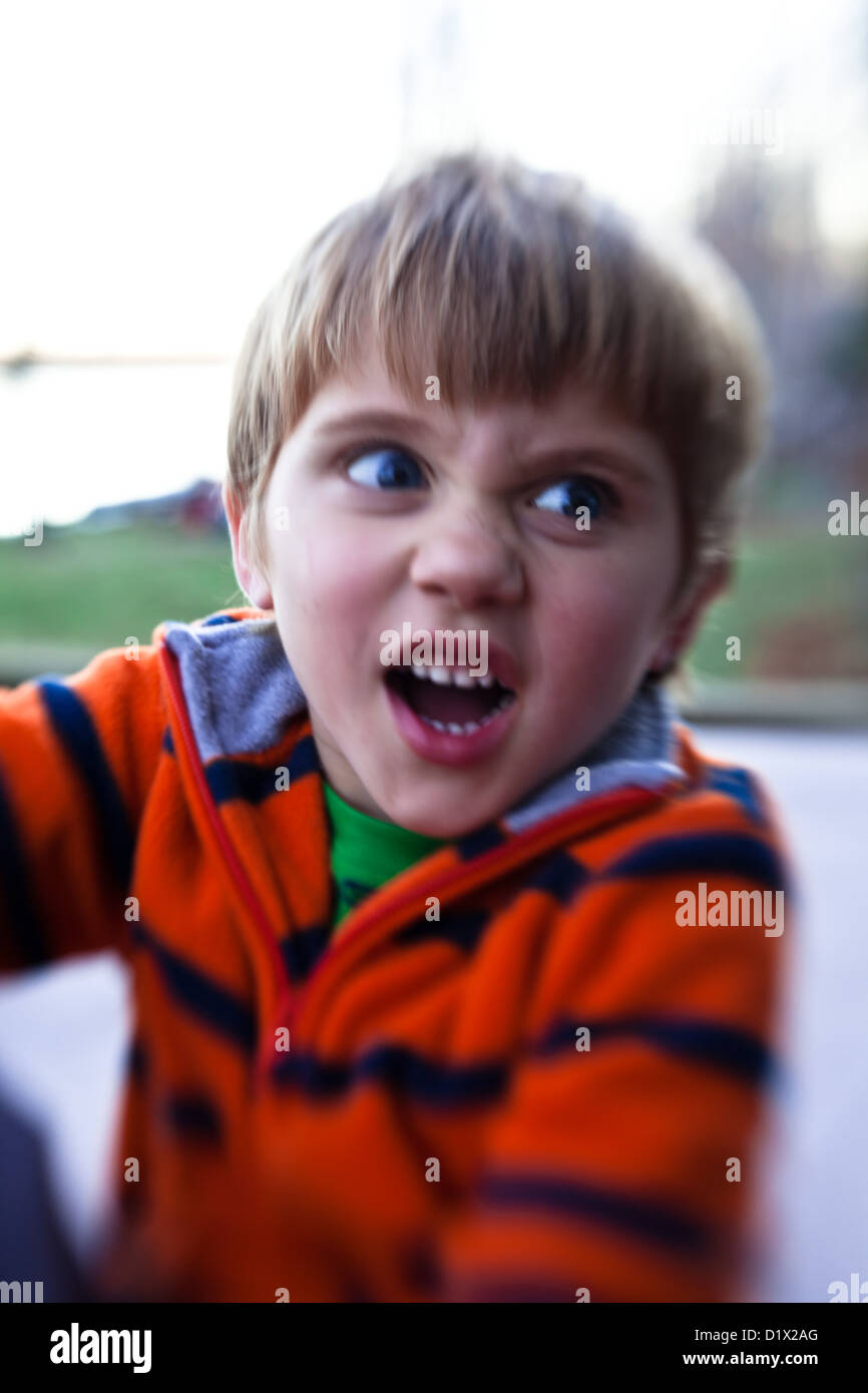 Little Boy making faces and being silly outside of his house Stock ...