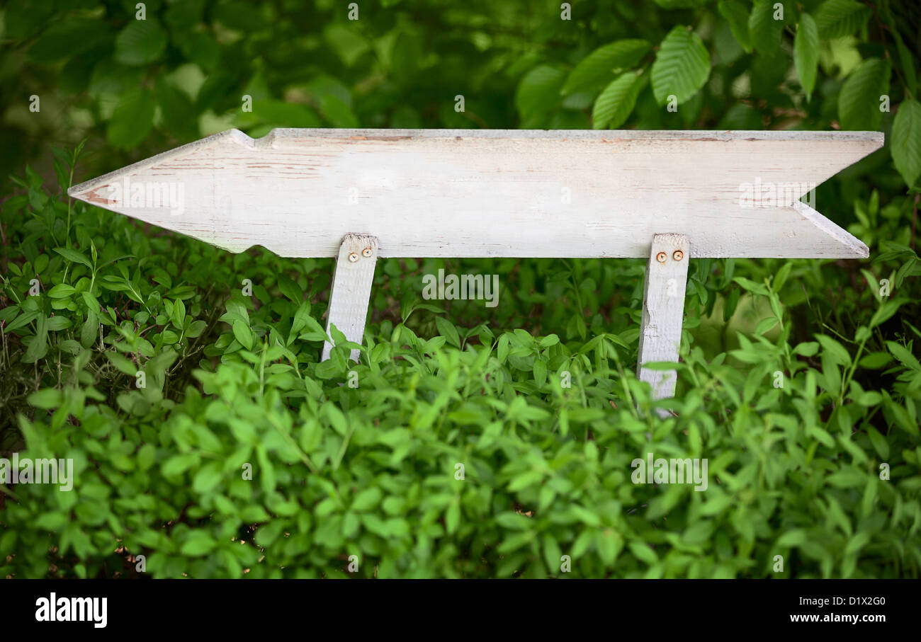 Old wooden arrow indicating the direction in the park Stock Photo - Alamy