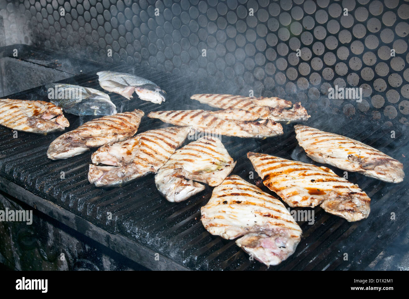cooking fish on the grill in the restaurant Stock Photo - Alamy