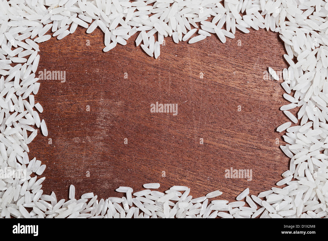 Rice background on wooden table Stock Photo - Alamy