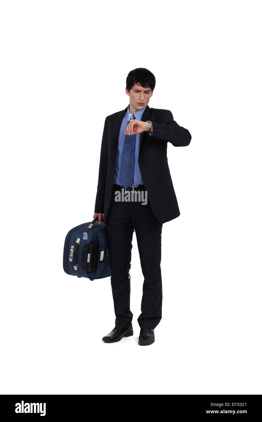 Businessman looking at his watch Stock Photo - Alamy