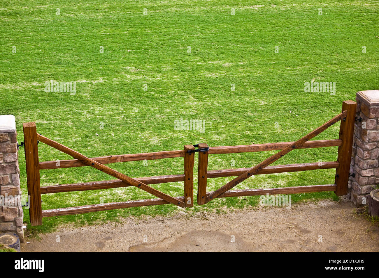 Picturesque wooden gate on stone pillars at horse arena Stock Photo - Alamy