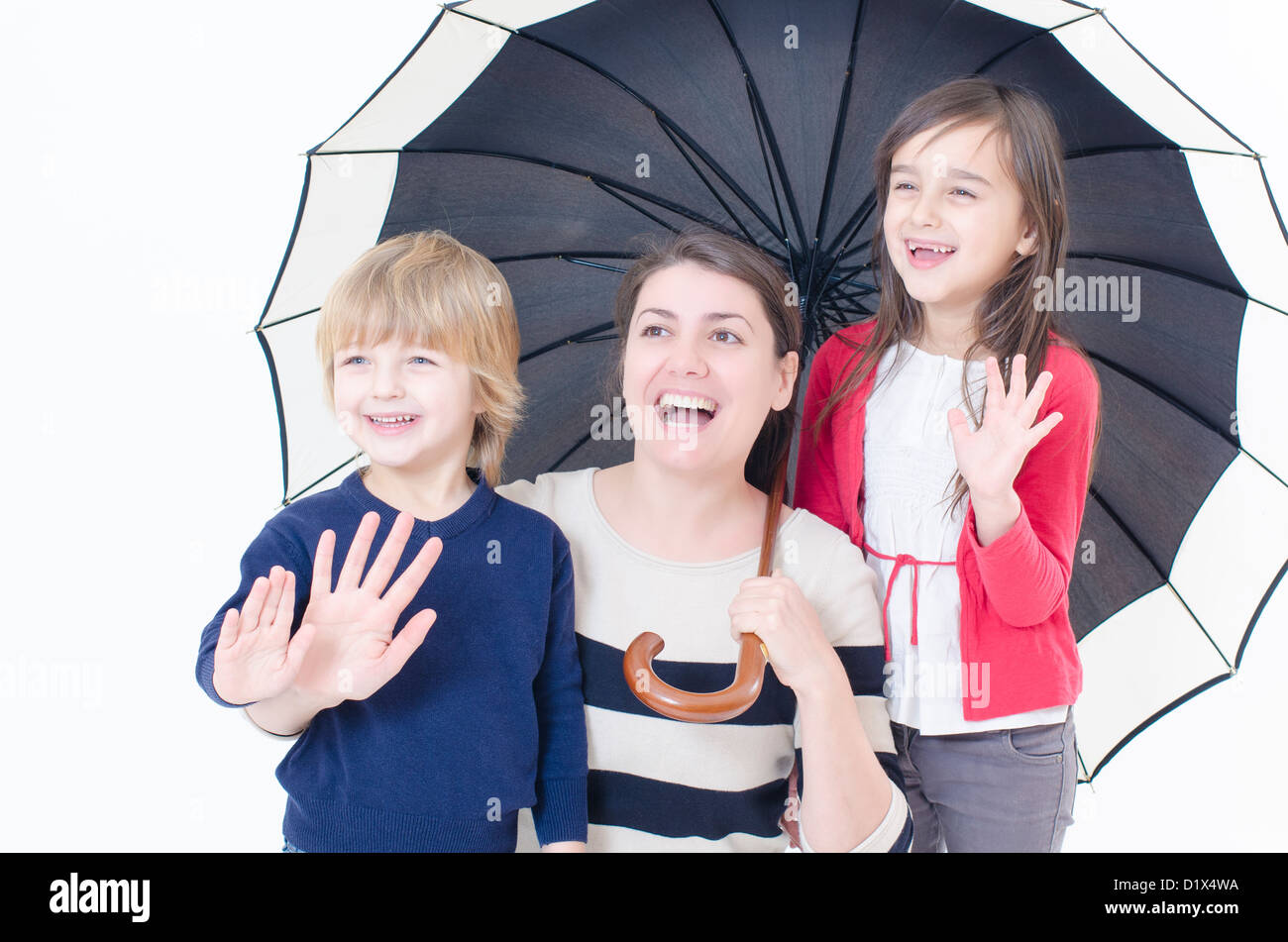 Two children and a woman saying welcome Stock Photo - Alamy