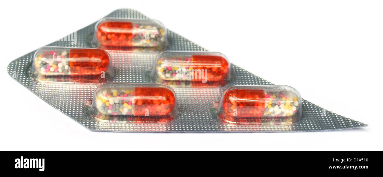 Close up of capsules over white background Stock Photo - Alamy