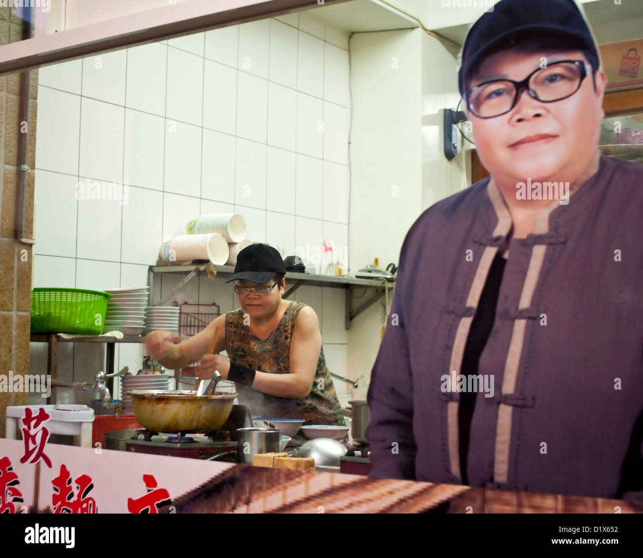 Cook in her kitchen with a huge cut-out Stock Photo - Alamy