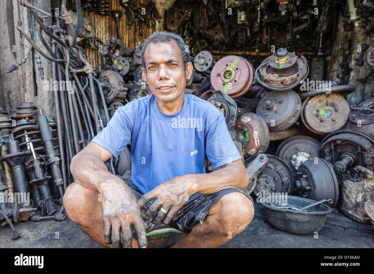 Mechanic in front of his street garage, Carbon market, Cebu ...