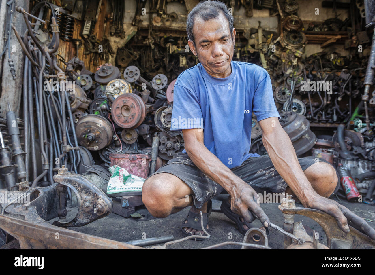 Mechanic in front of his street garage, Carbon market, Cebu ...