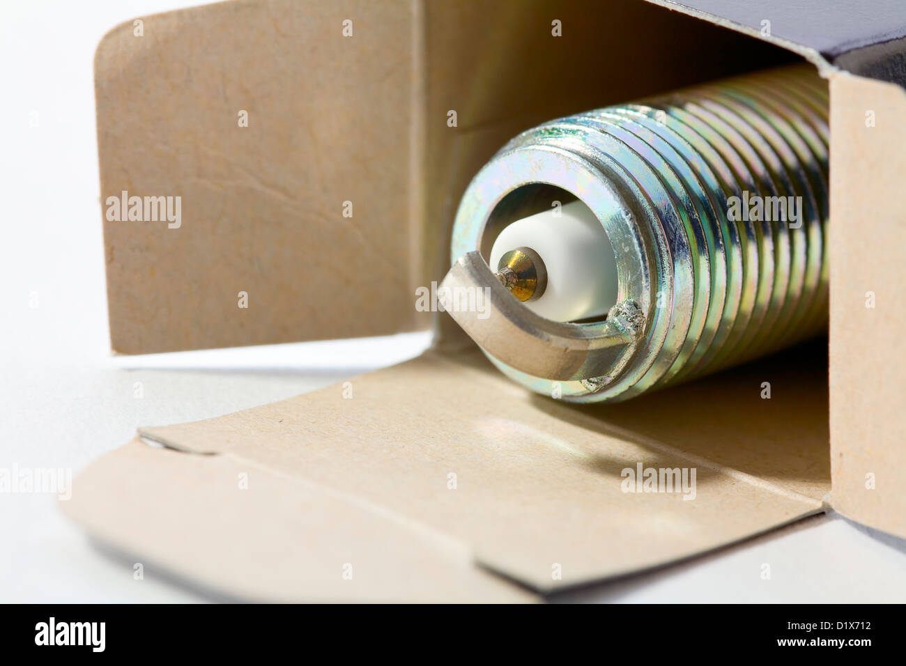 Close up of a spark plug in a cardboard box on white background Stock ...
