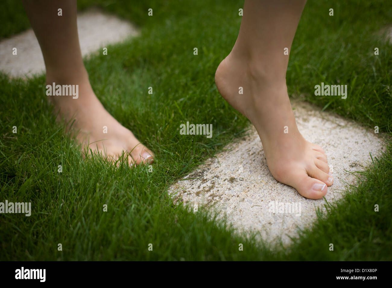 Woman's feet on grass Stock Photo - Alamy