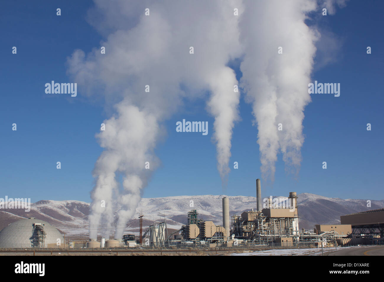 Power Plant smokestacks with blue skies and mountains Stock Photo - Alamy