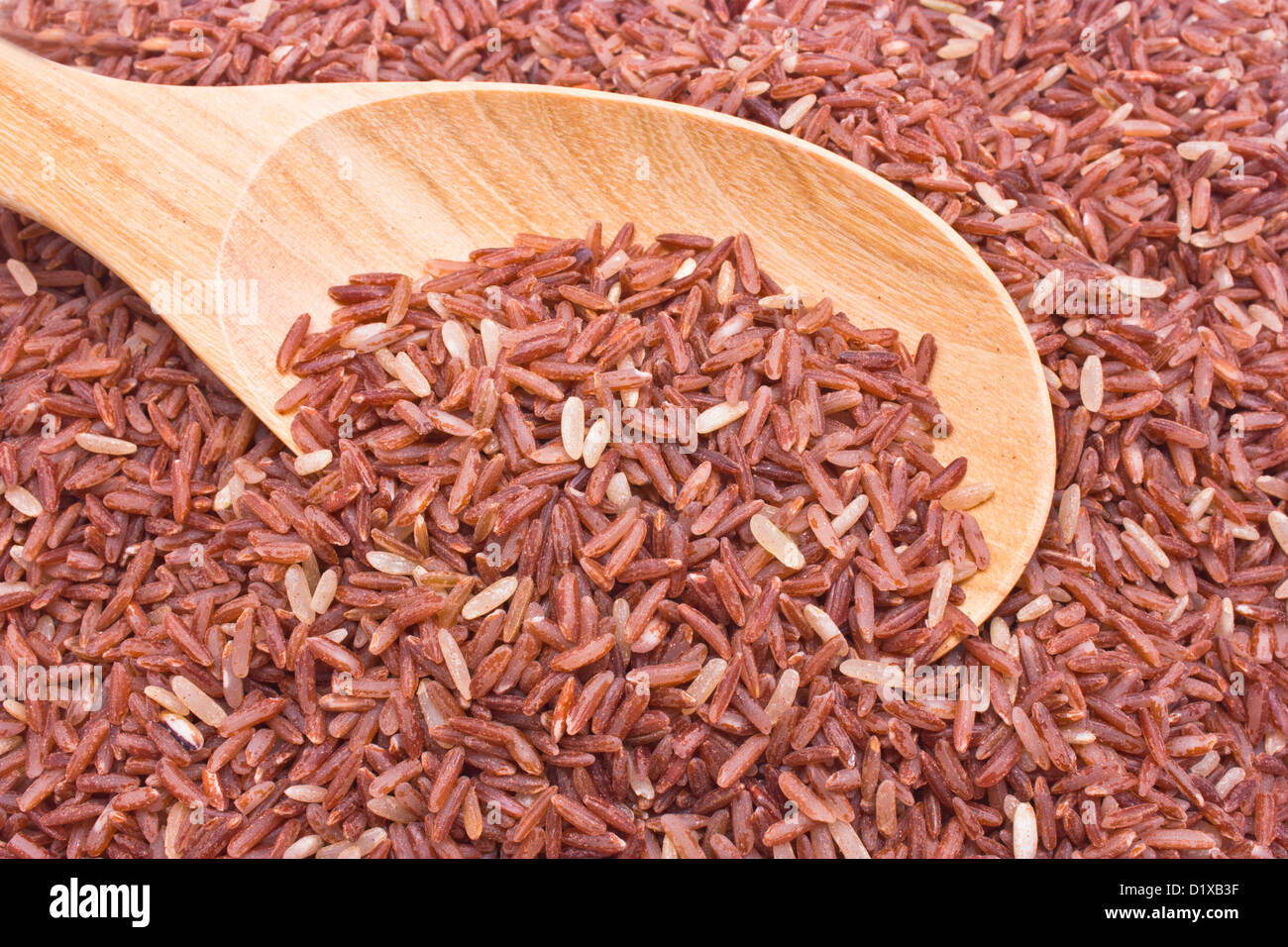 Organic brown rice with wooden spoon Stock Photo - Alamy