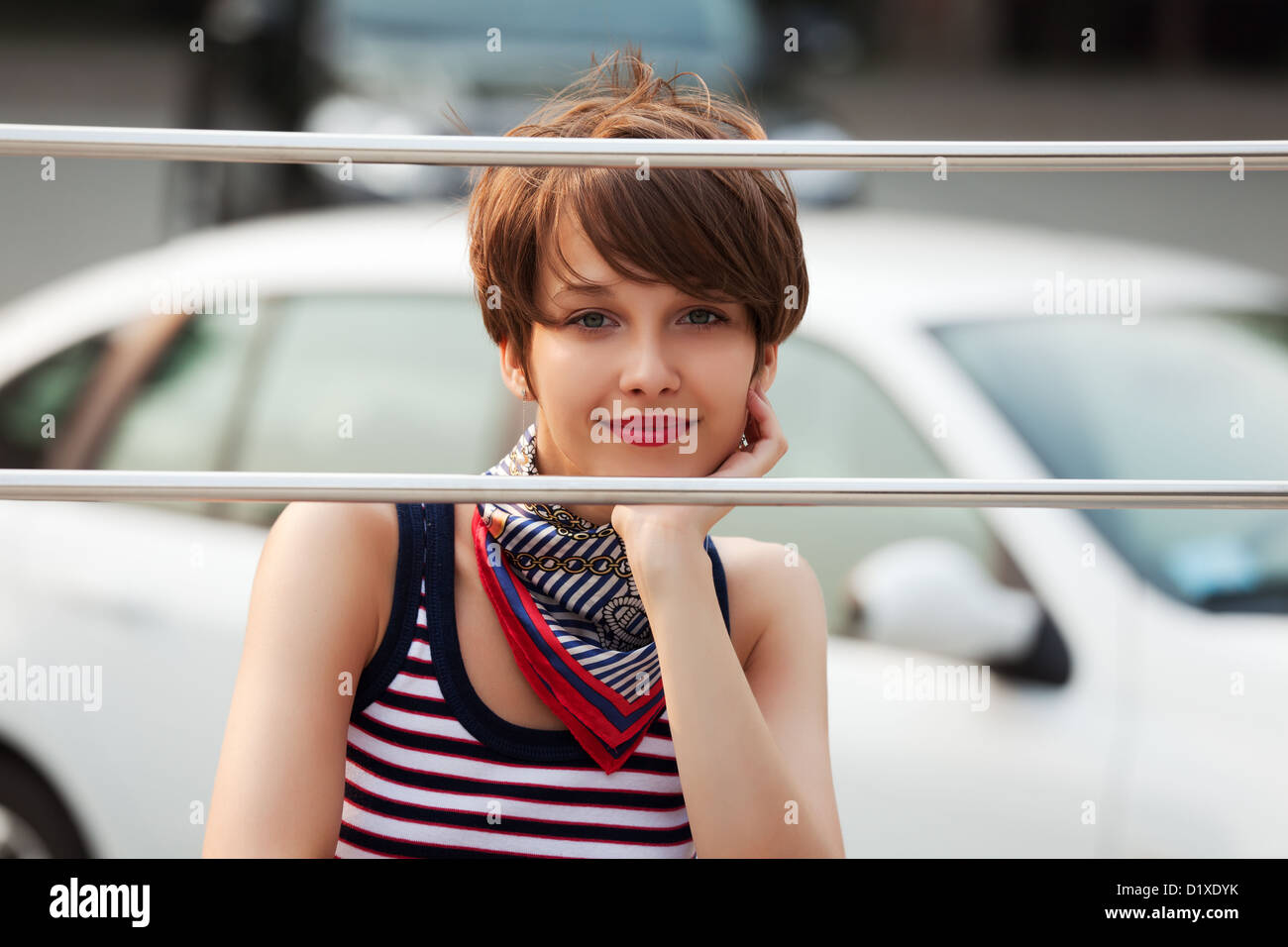 Happy young woman against a car parking Stock Photo - Alamy