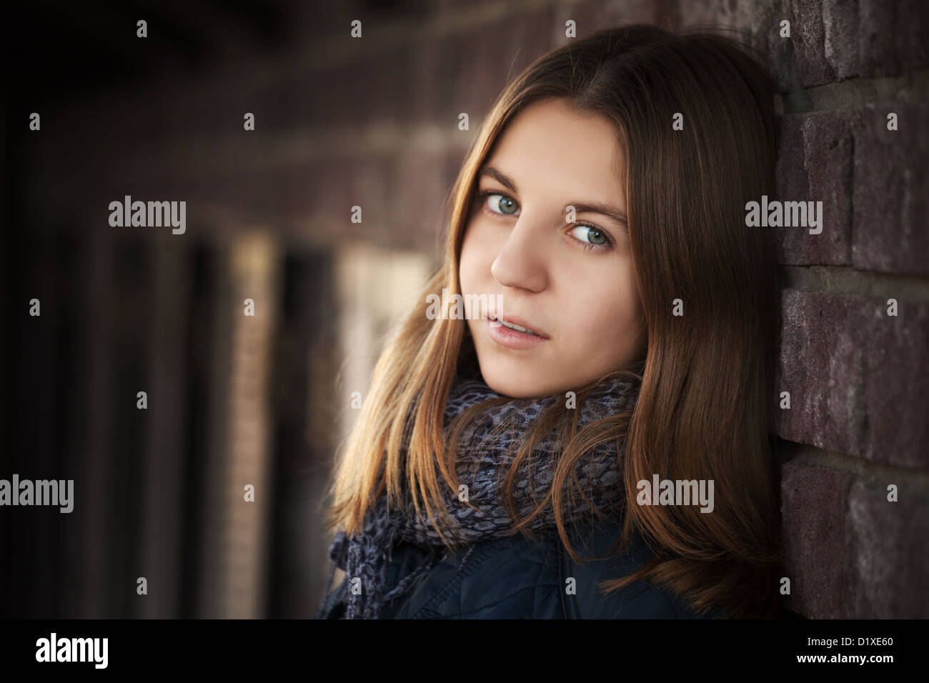 Teenage girl against a brick wall Stock Photo - Alamy