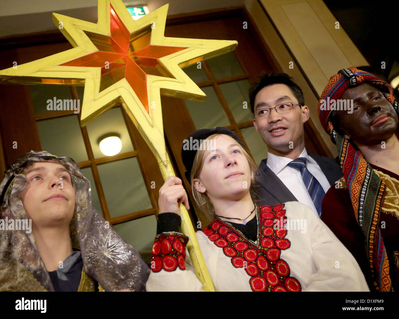 The Chairman of the FDP, Philipp Roesler (R, back) stands between ...