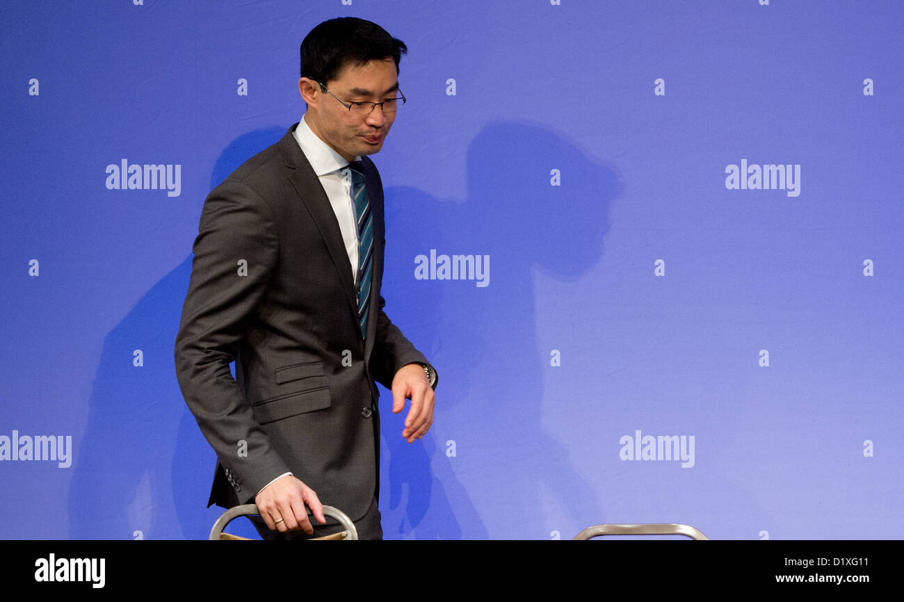 The chairman of the FDP, Philipp Roesler, walks back to his seat after ...