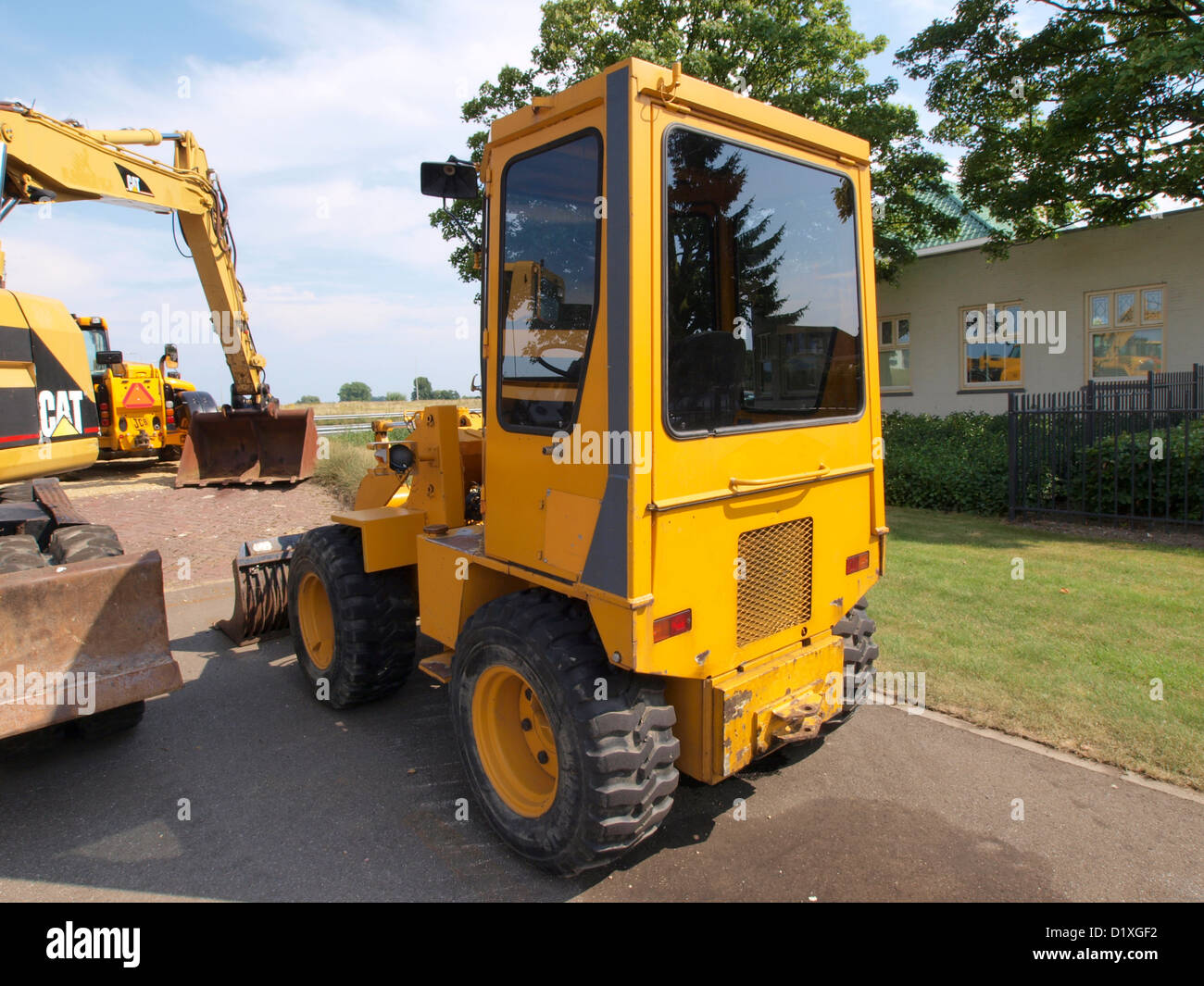 The yellow front-end loader is a heavy-duty construction machine used ...