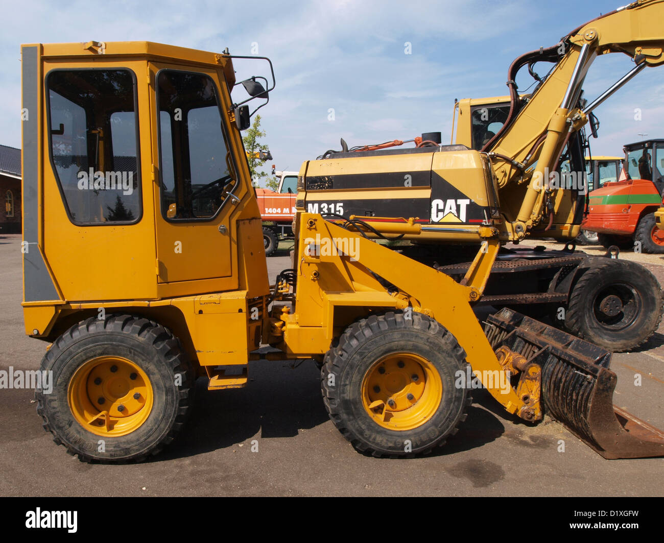 A yellow front-end loader is a heavy construction vehicle used for ...