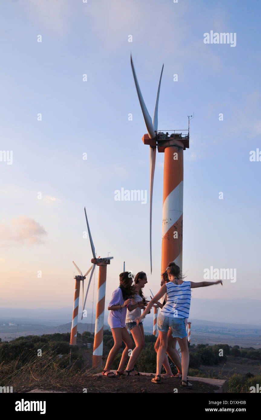 Excited young girls stand near Wind turbines. Photographed in Israel ...