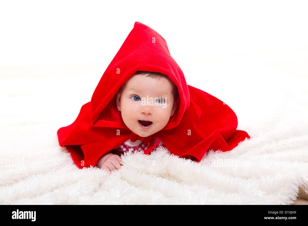 Baby Little Red Riding Hood on white fur with funny expression Stock ...