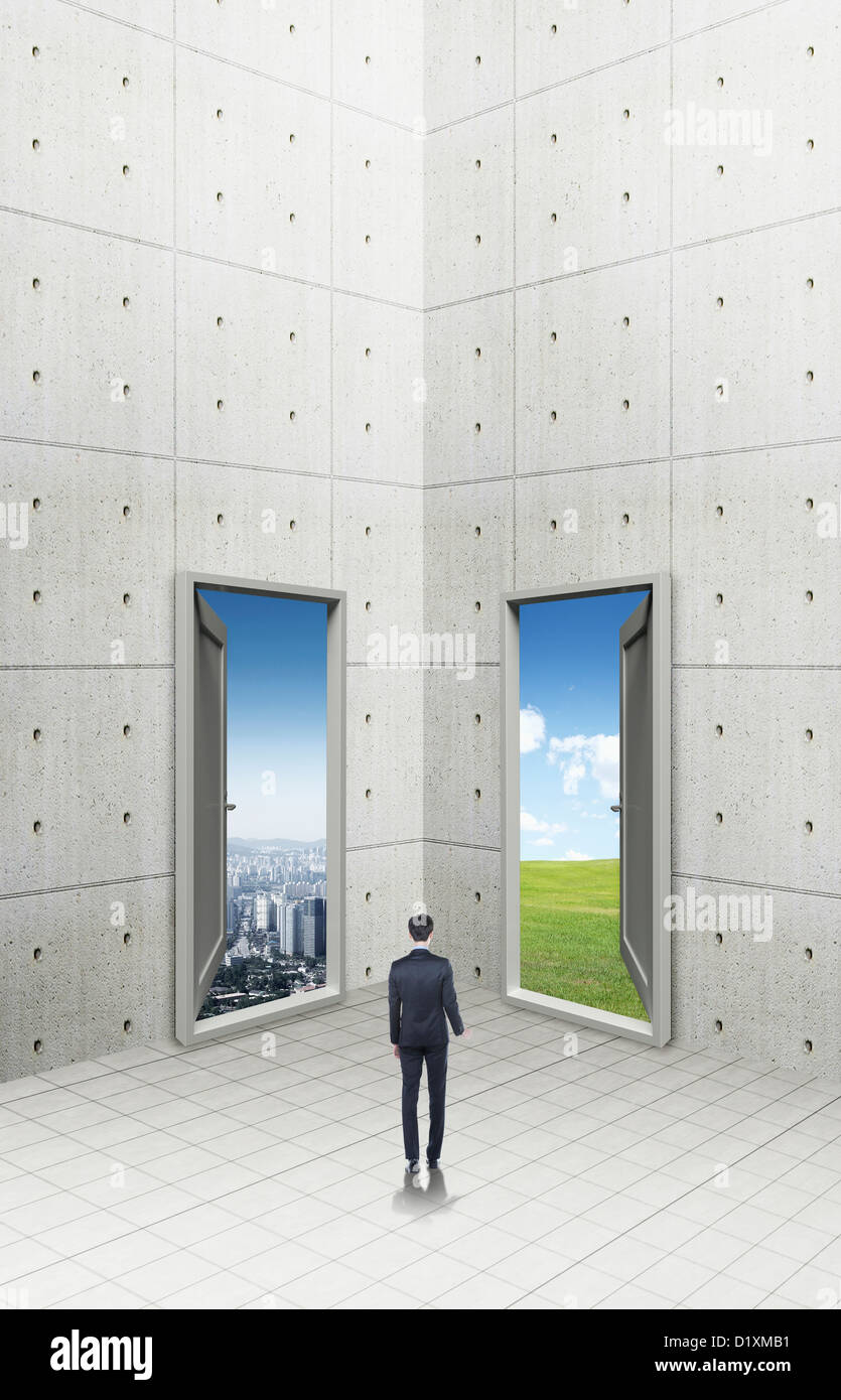 a businessman facing two different doors Stock Photo - Alamy