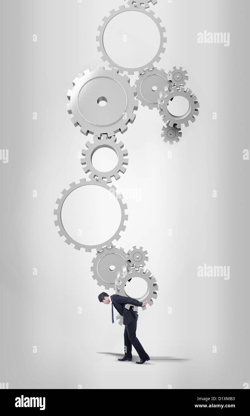 a businessman holding gear set with his back Stock Photo - Alamy