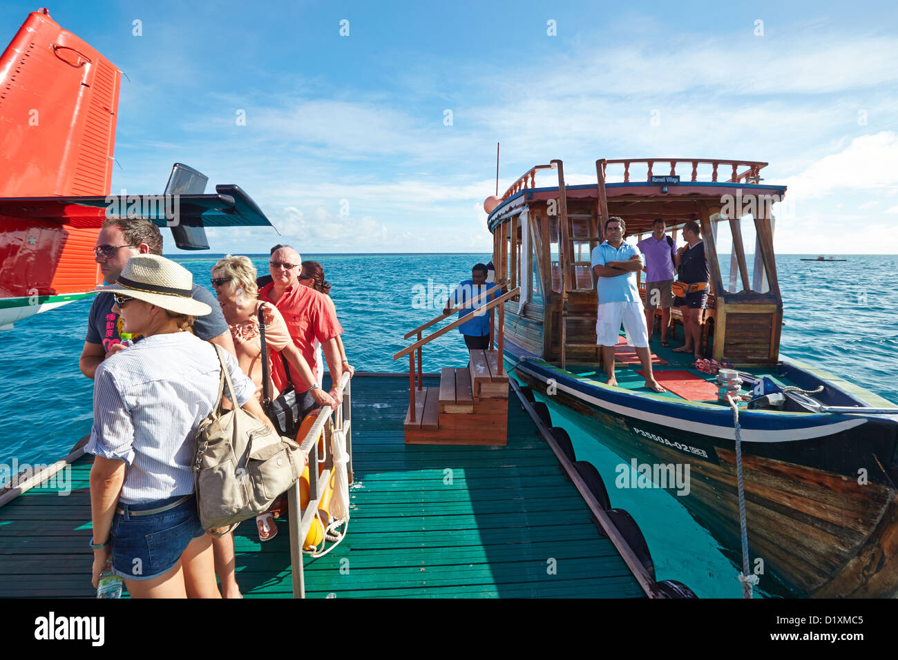 Passengers wait on a floating jetty to board a Maldivian Air Taxi ...