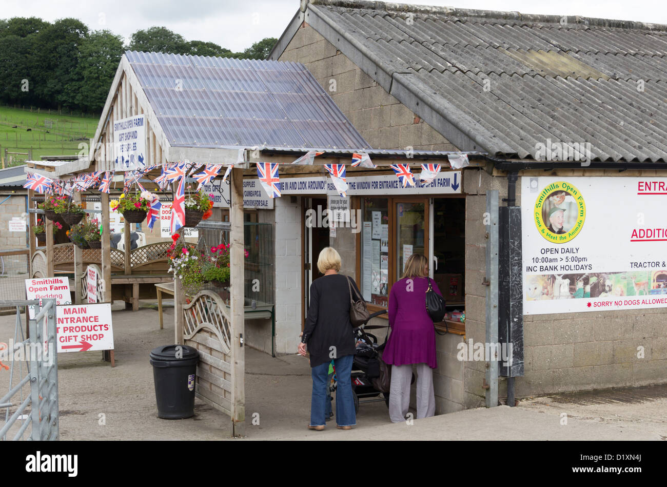 Smithills Open Farm near Bolton. Two women and a child in a buggy at ...