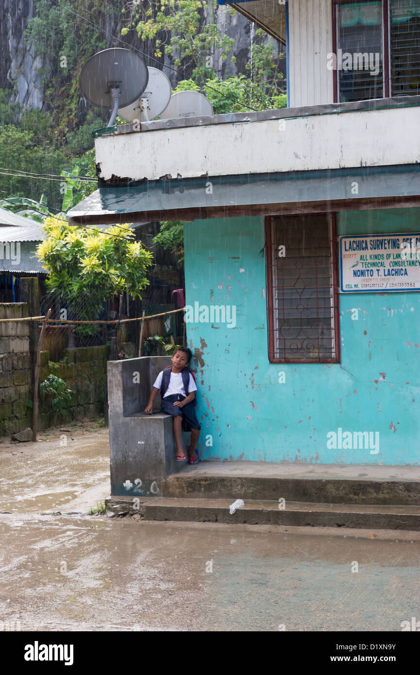 Young boy taking protection from the rain, El Nido, Palawan and The ...