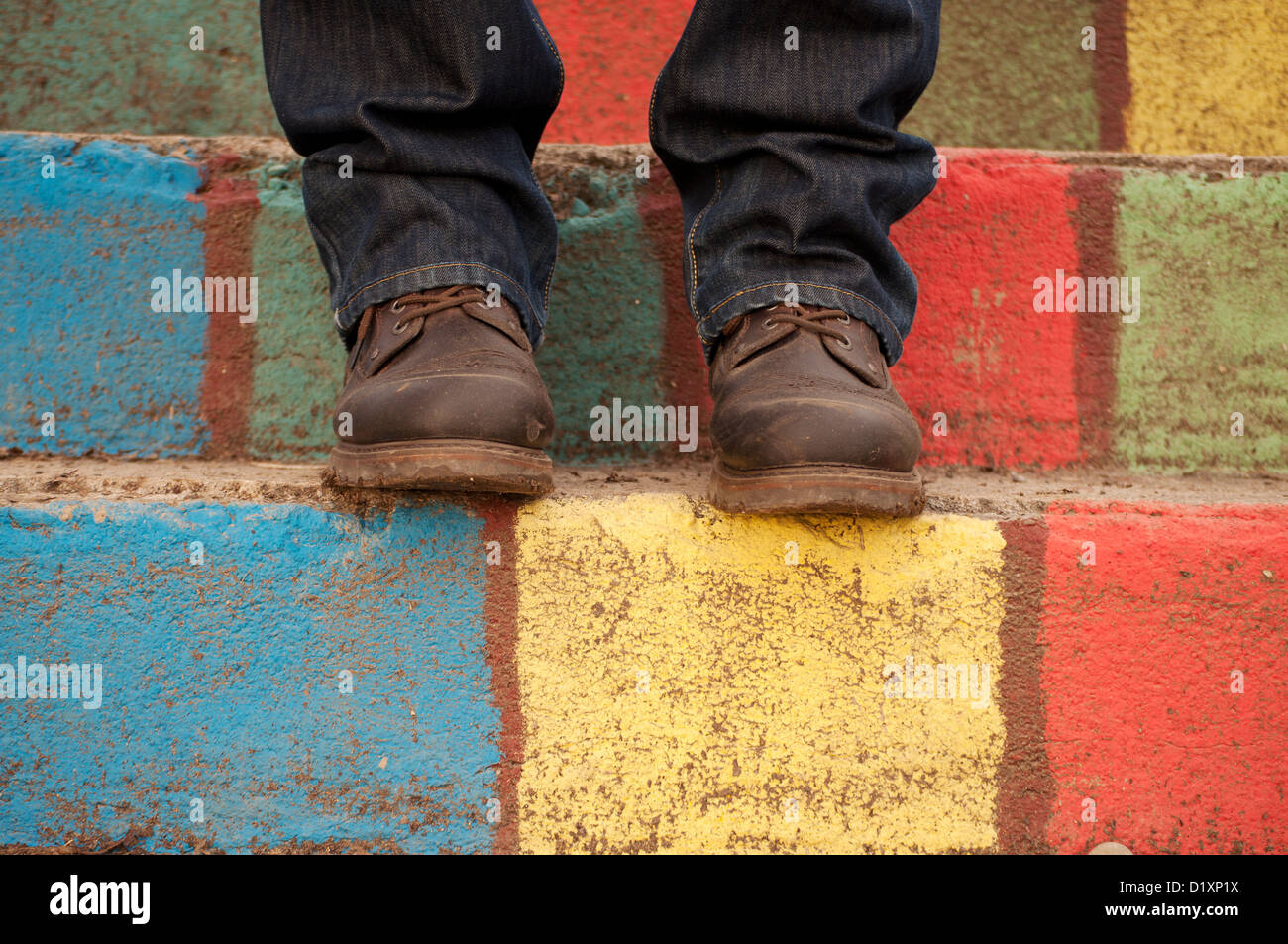 Man standing on colorful stairs Stock Photo - Alamy