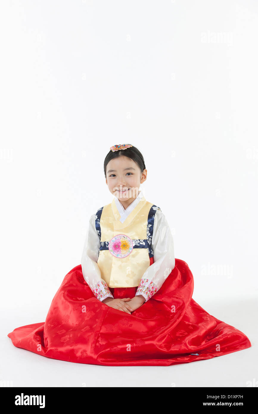 a girl sitting on a floor wearing a Hanbok dress Stock Photo - Alamy