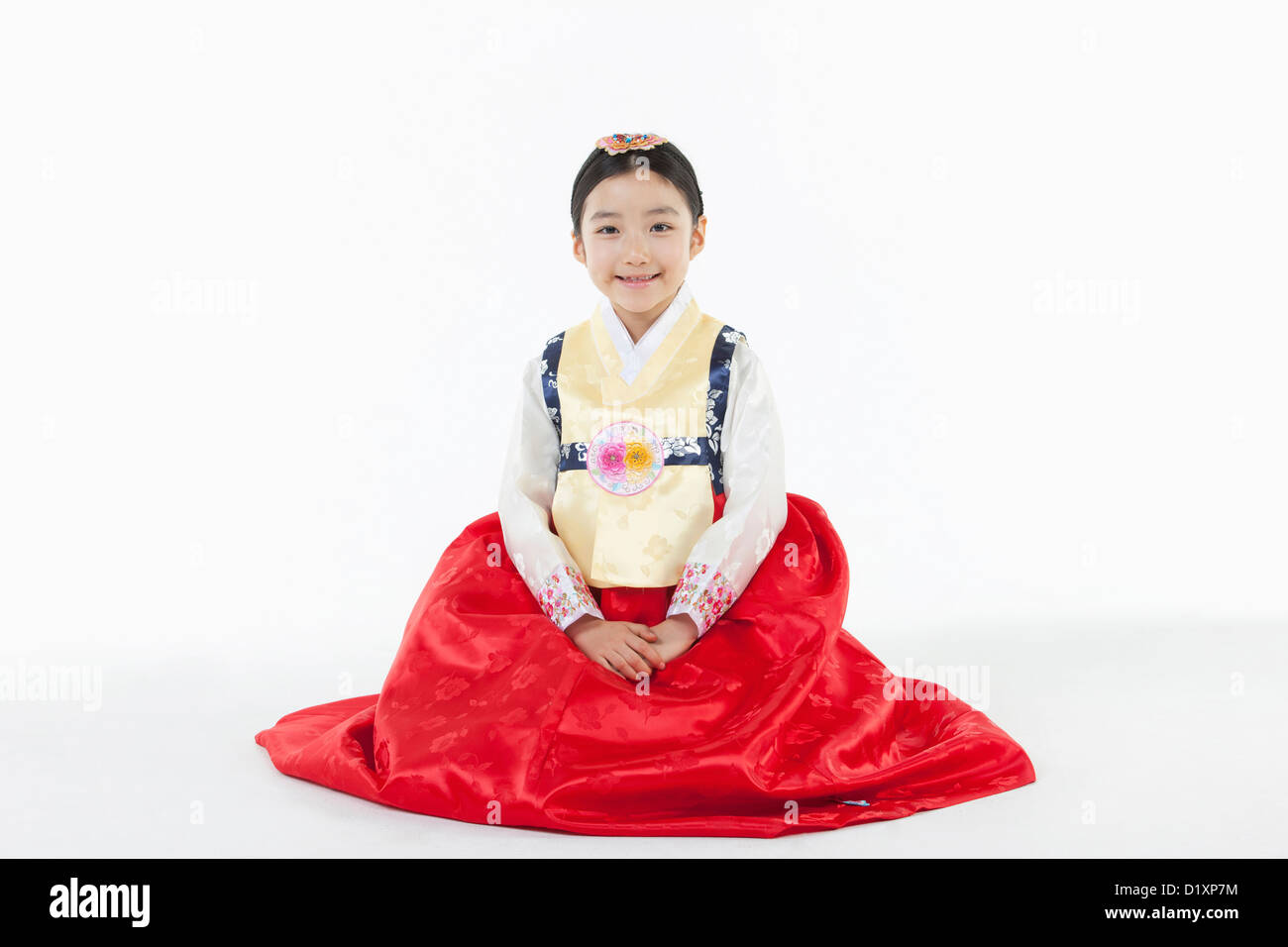 a girl sitting on a floor wearing a Hanbok dress Stock Photo - Alamy